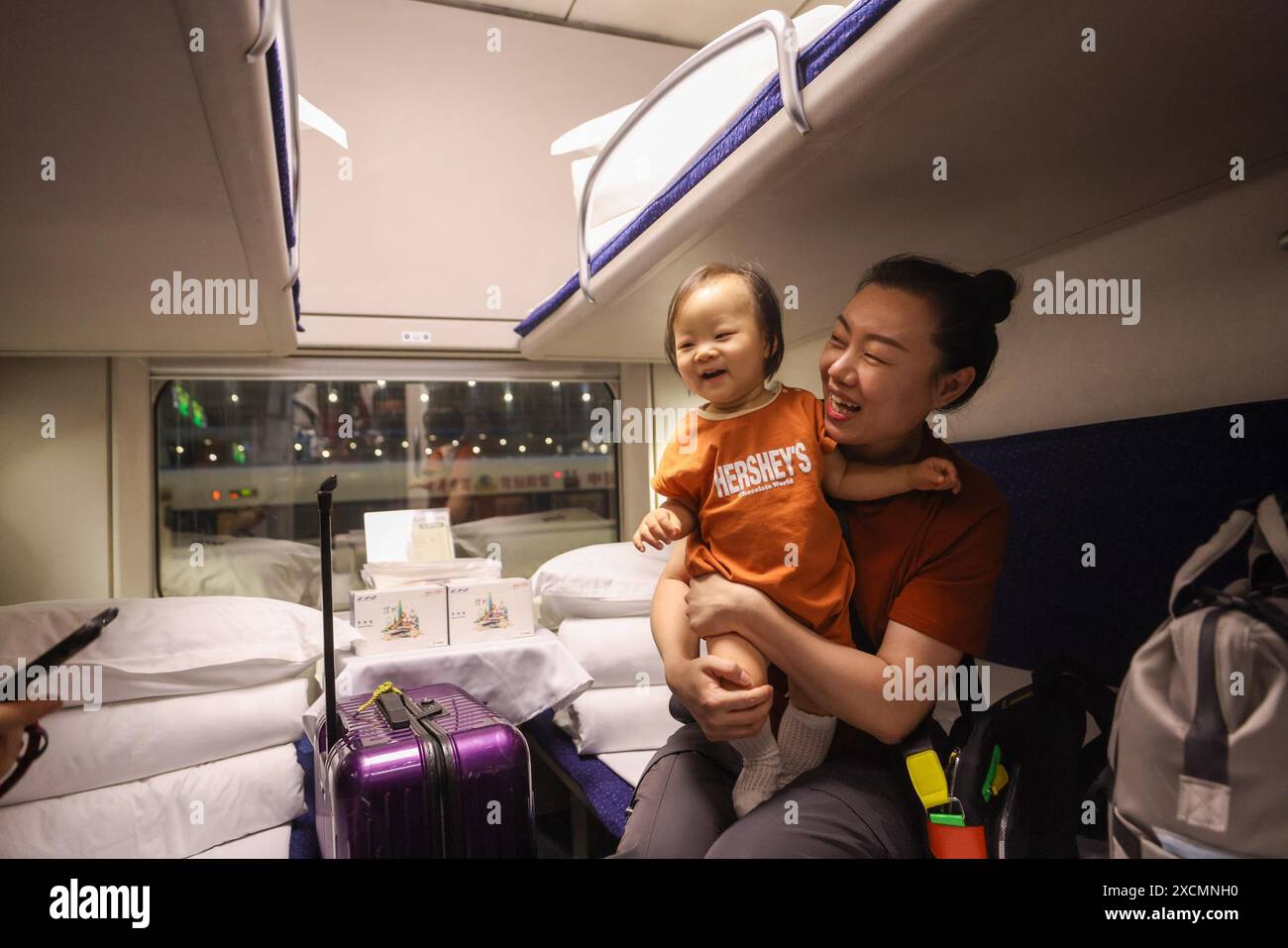 **CHINESE MAINLAND, HONG KONG, MACAU AND TAIWAN OUT** A passenger and her baby take the D909 ...