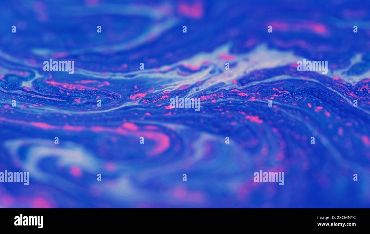 Sparkling paint. Glitter ink flow. Defocused blue white pink color ...