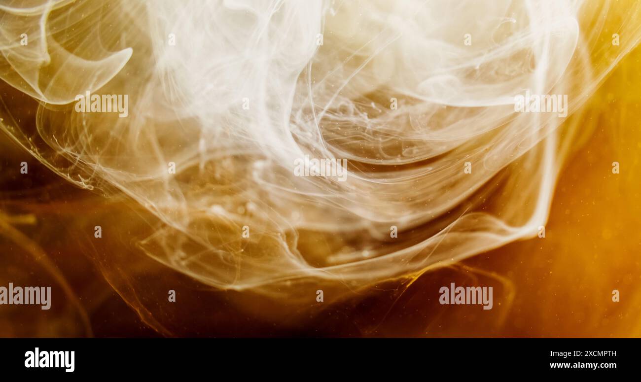 Ink drop water. Smoke cloud. Blur yellow brown white color glowing haze ...
