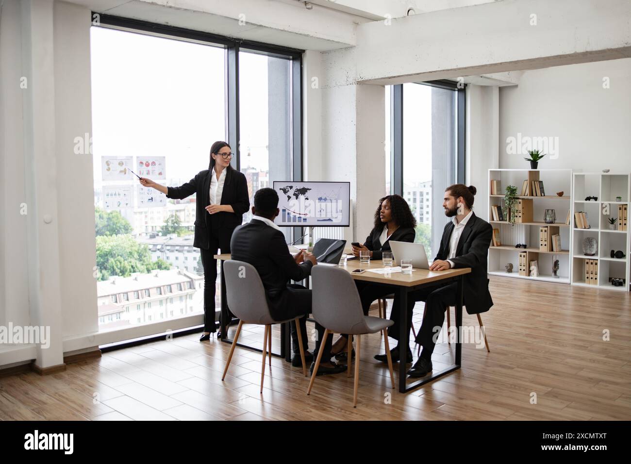 Business woman giving presentation to colleagues in modern office Stock ...