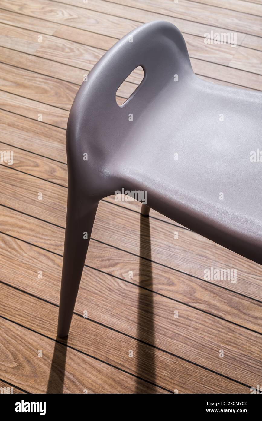Detail Of A Scandinavian Design Gray Plastic Chair Standing On A Wooden ...