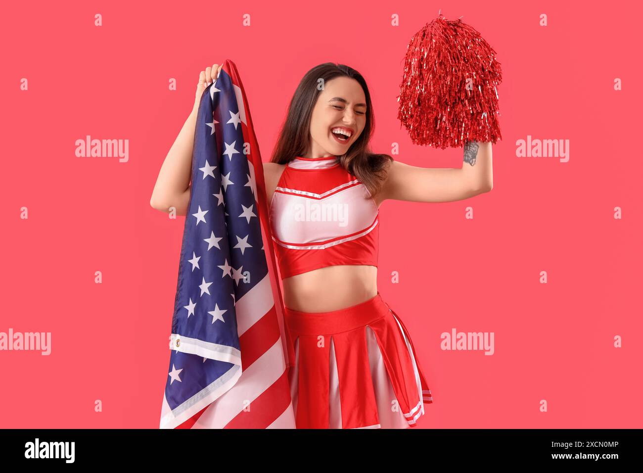 Female cheerleader with USA flag on red background Stock Photo - Alamy