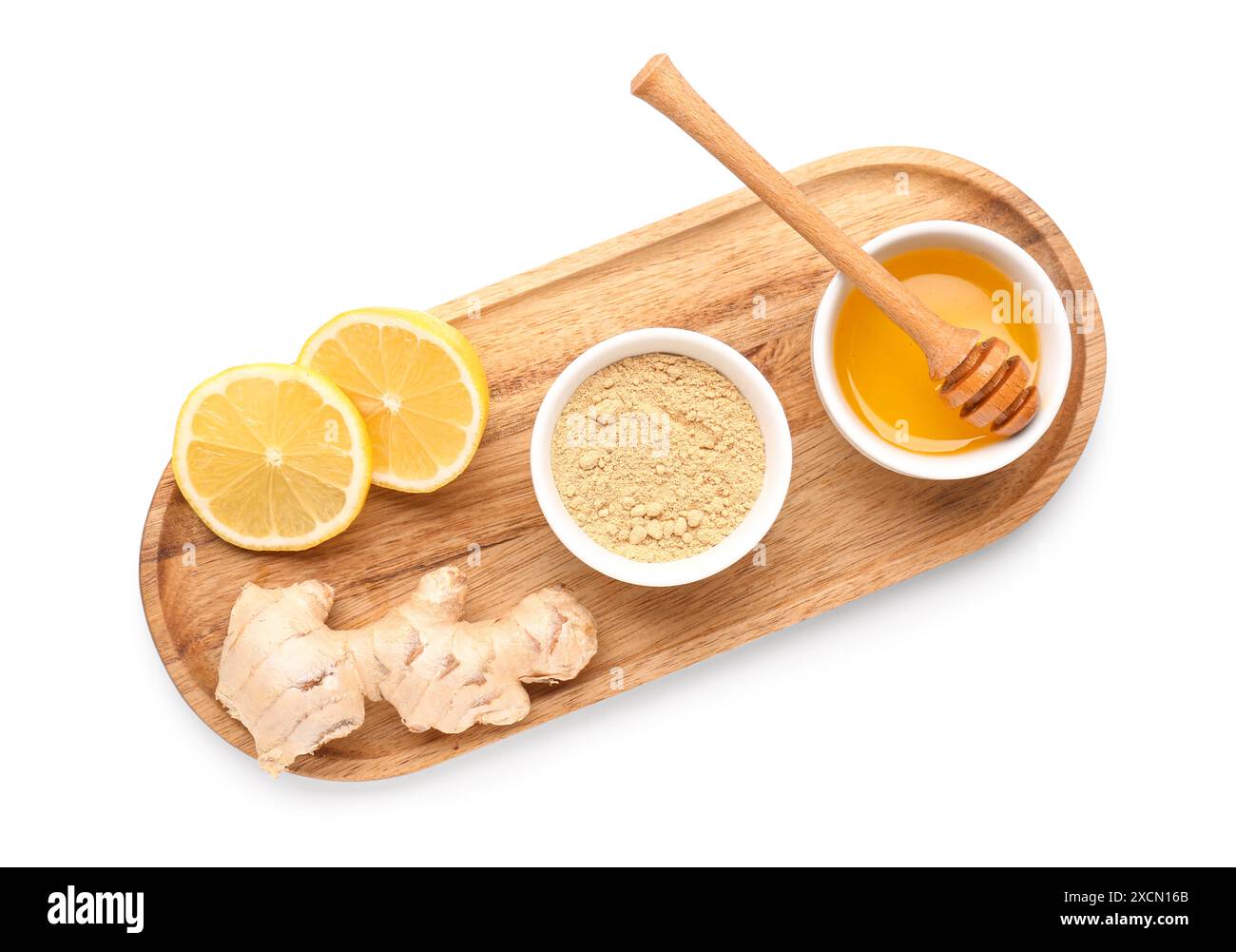 Wooden board with fresh ginger root and bowl of dried powder on white ...