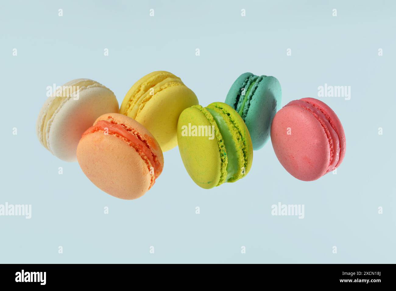 Flying sweet macaroons on white background Stock Photo - Alamy