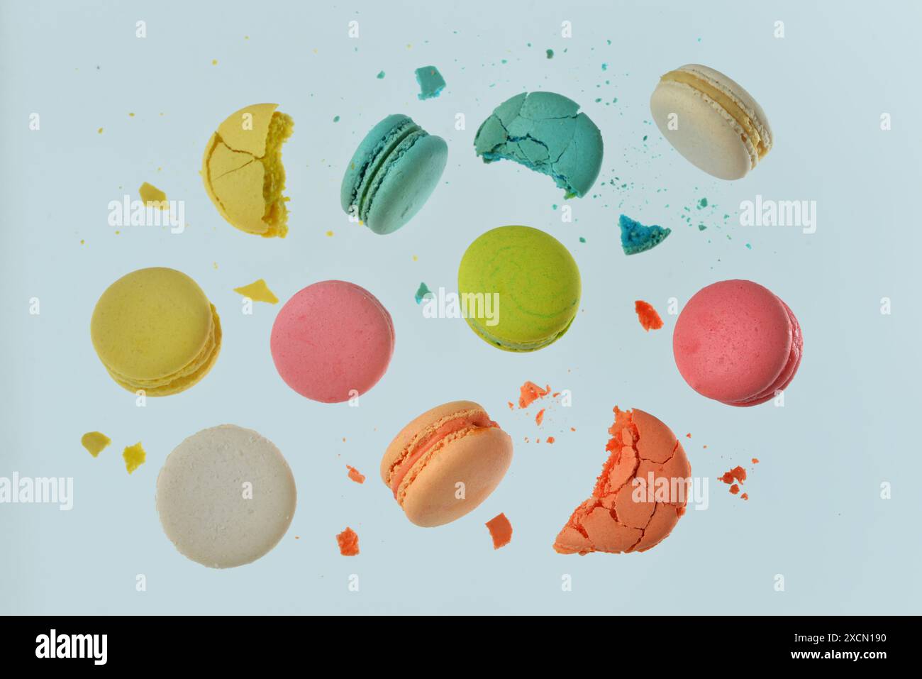 Flying sweet macaroons on white background Stock Photo - Alamy