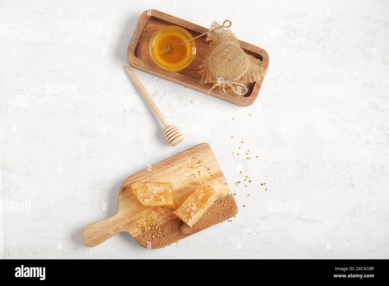 Bowl of sweet honey, combs and bee pollen on light background Stock ...