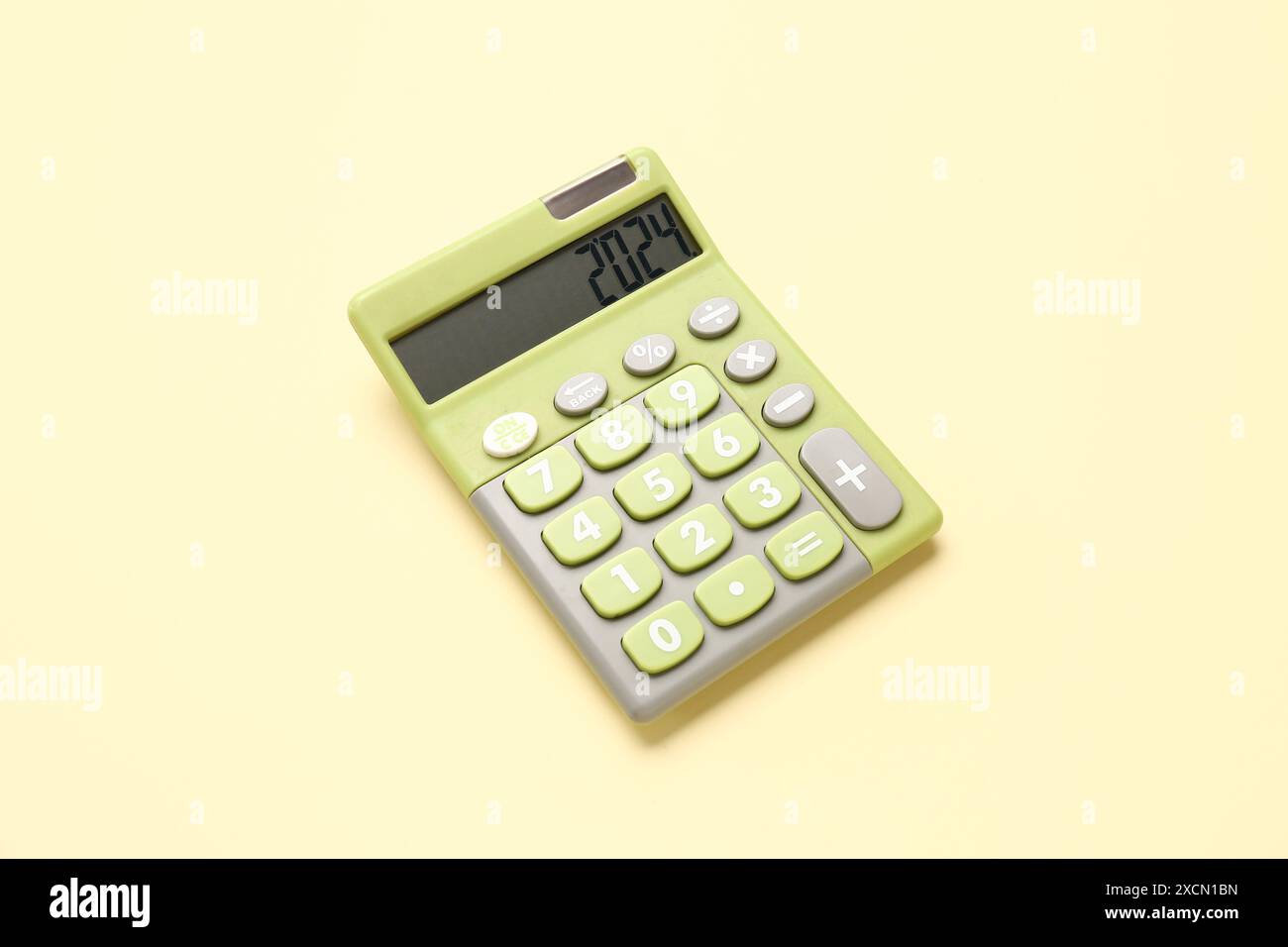 Calculator with number 2024 on yellow background Stock Photo - Alamy