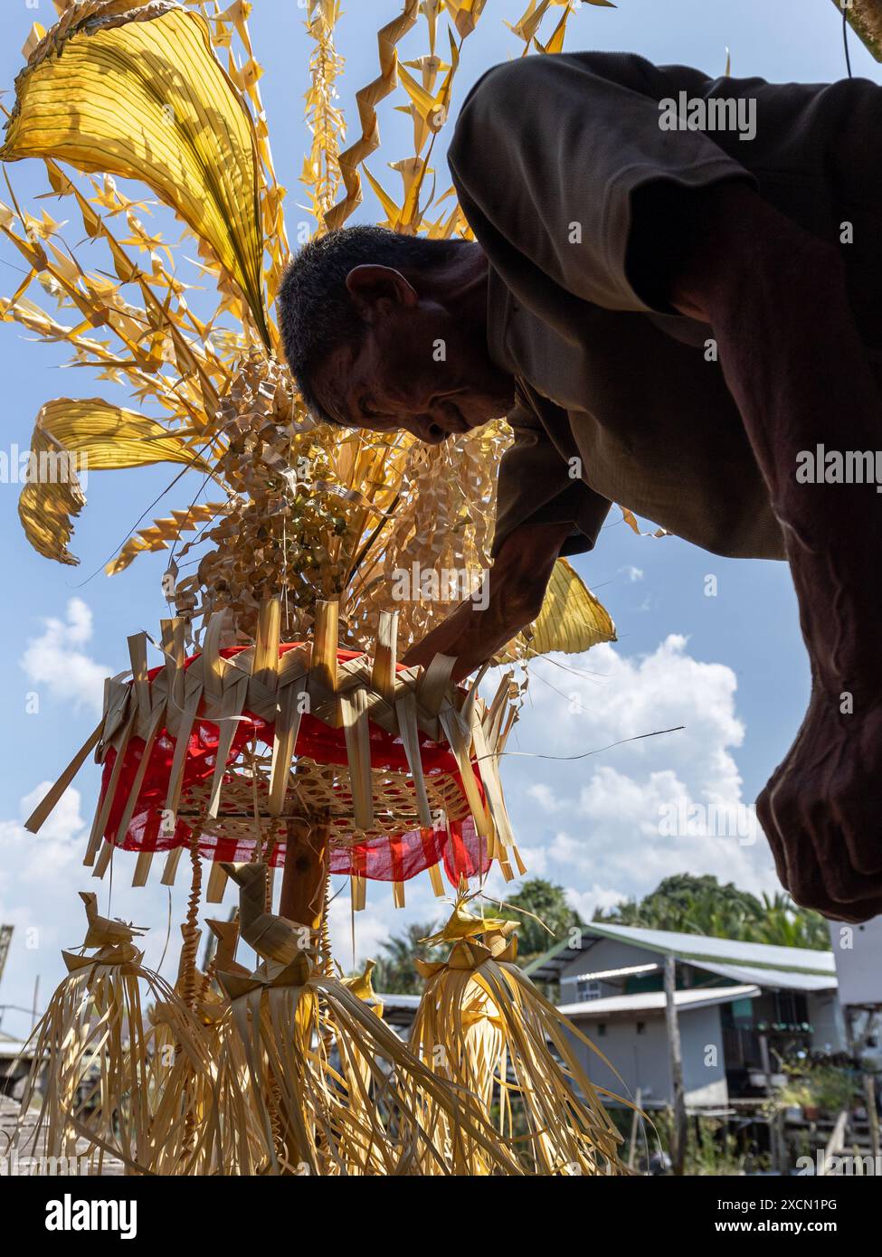 A men prepare traditional props for Melanau serahang ritual during Kaul ...