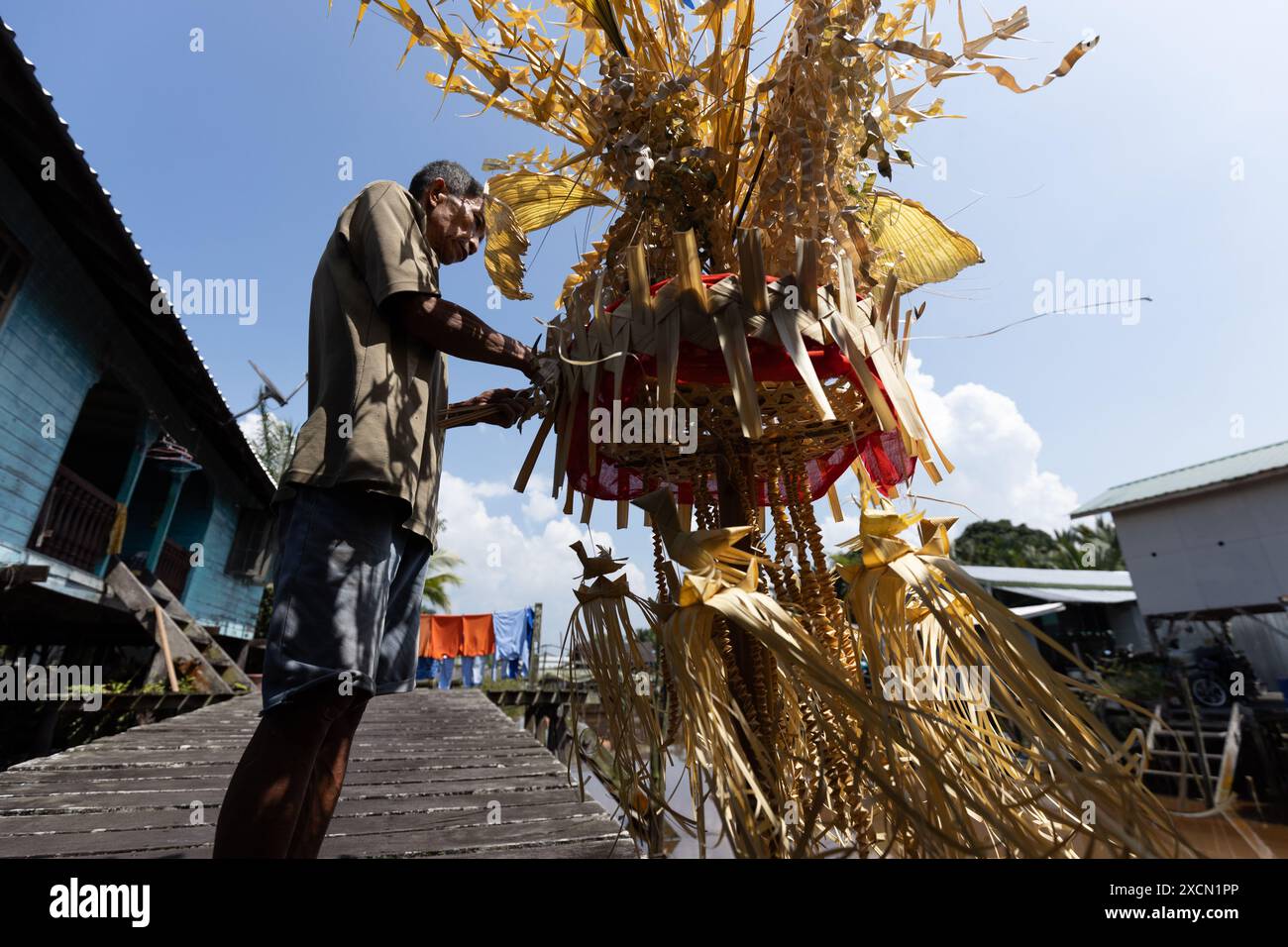 A men prepare traditional props for Melanau serahang ritual during Kaul ...