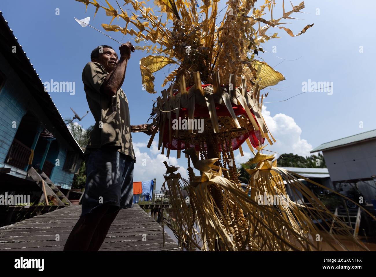 A men prepare traditional props for Melanau serahang ritual during Kaul ...