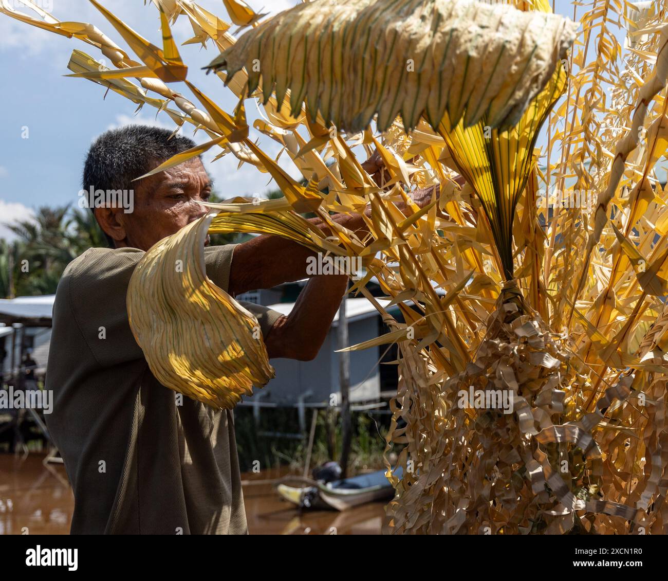 A men prepare traditional props for Melanau serahang ritual during Kaul ...