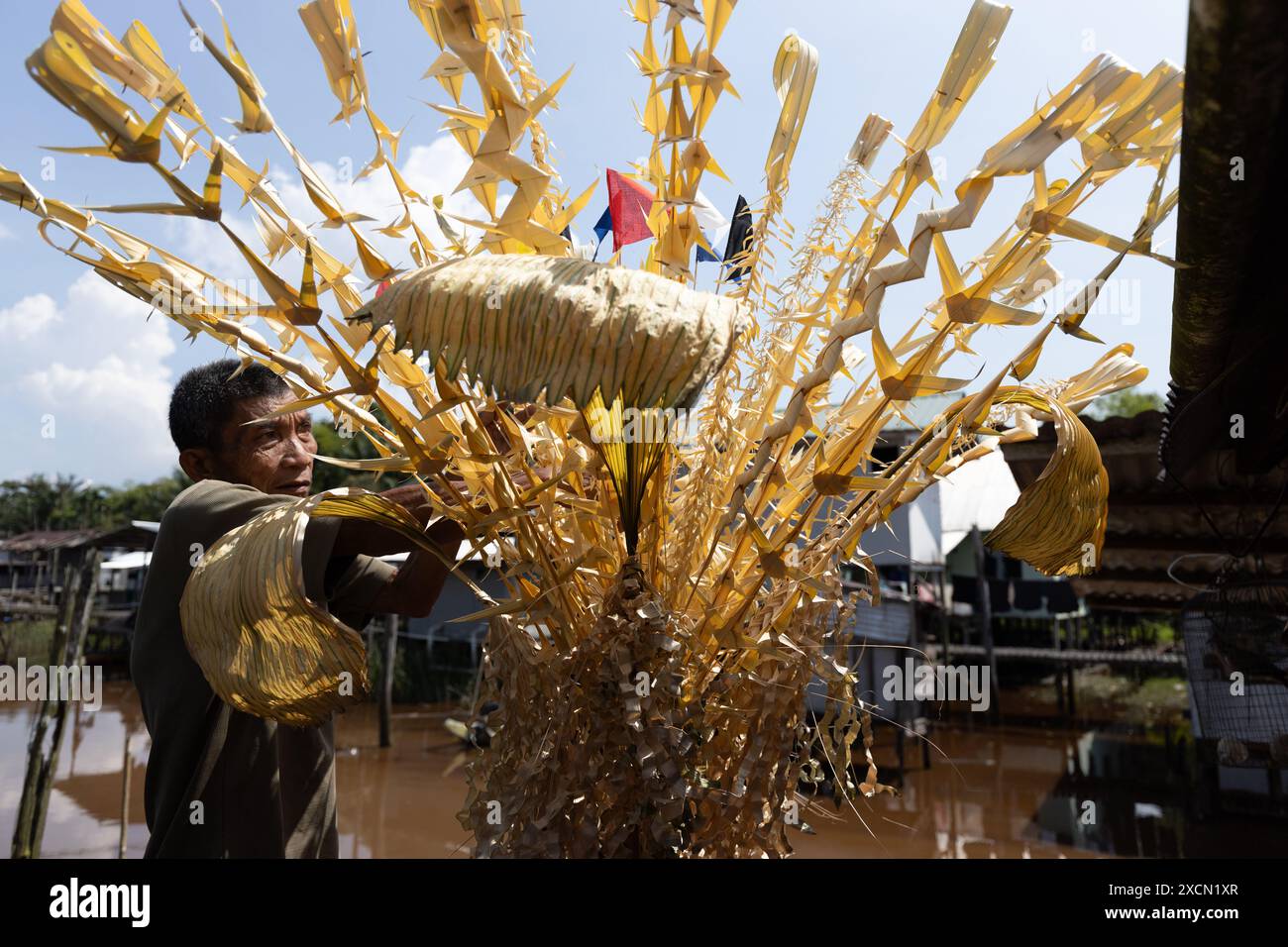 A men prepare traditional props for Melanau serahang ritual during Kaul ...