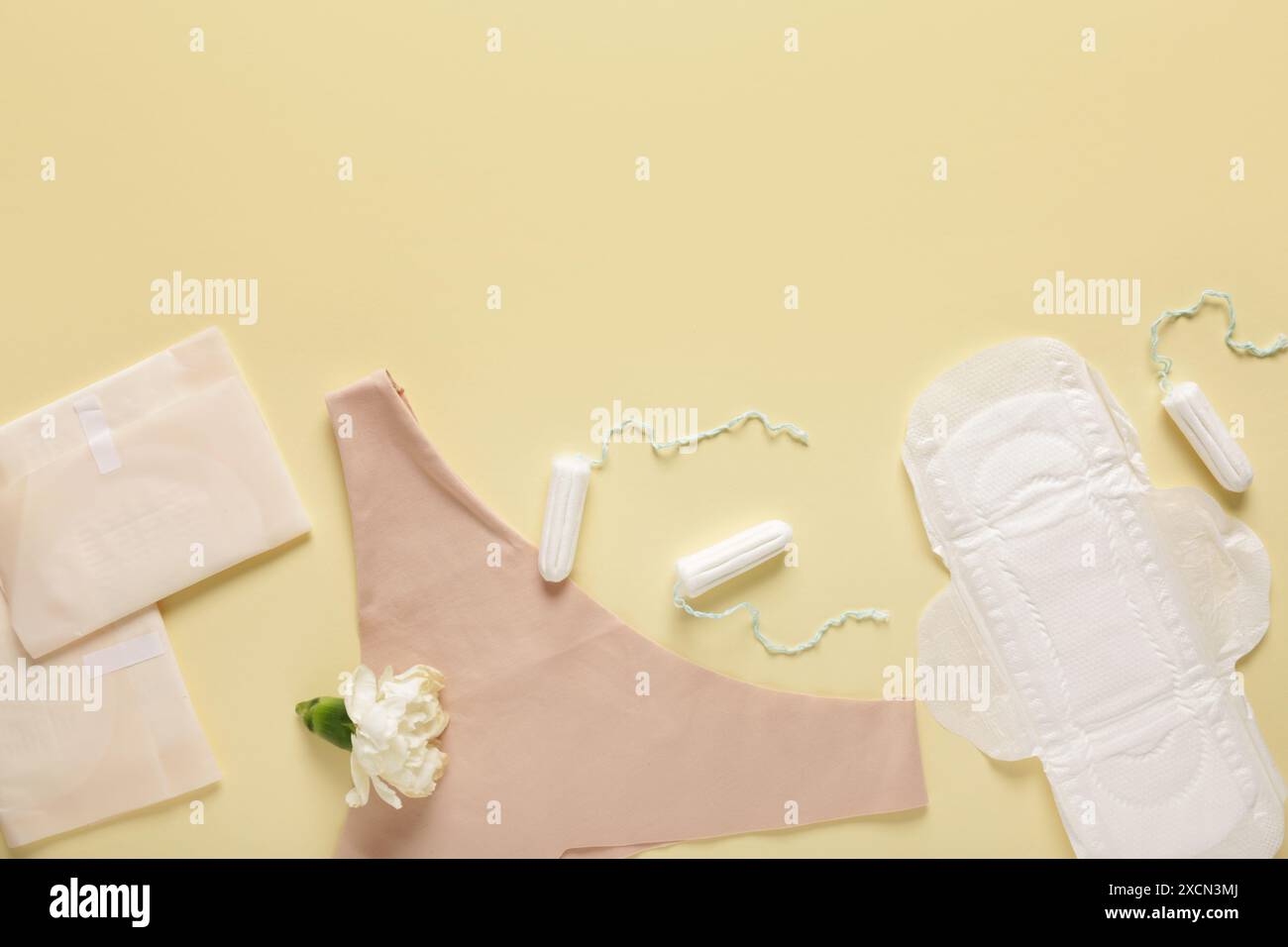 Menstrual pads with tampons and underpants on yellow background Stock ...