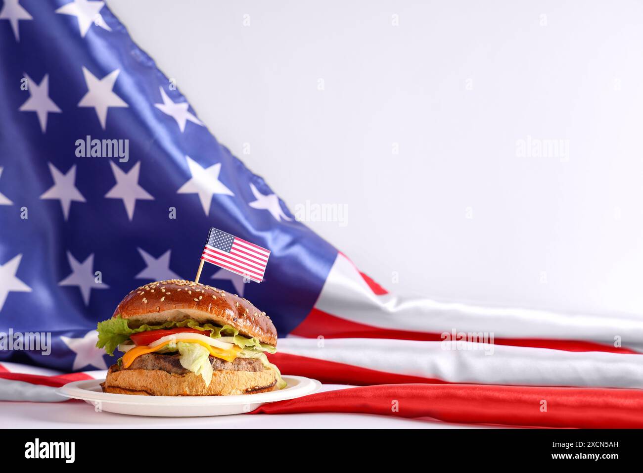 Tasty burger with flags of USA on white background. American ...