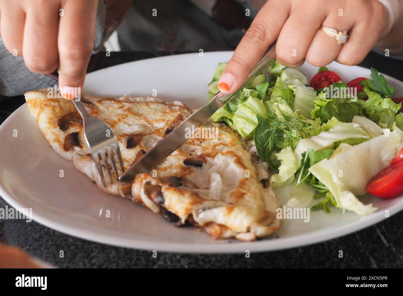 eating Plain Egg Omelette on table Stock Photo - Alamy