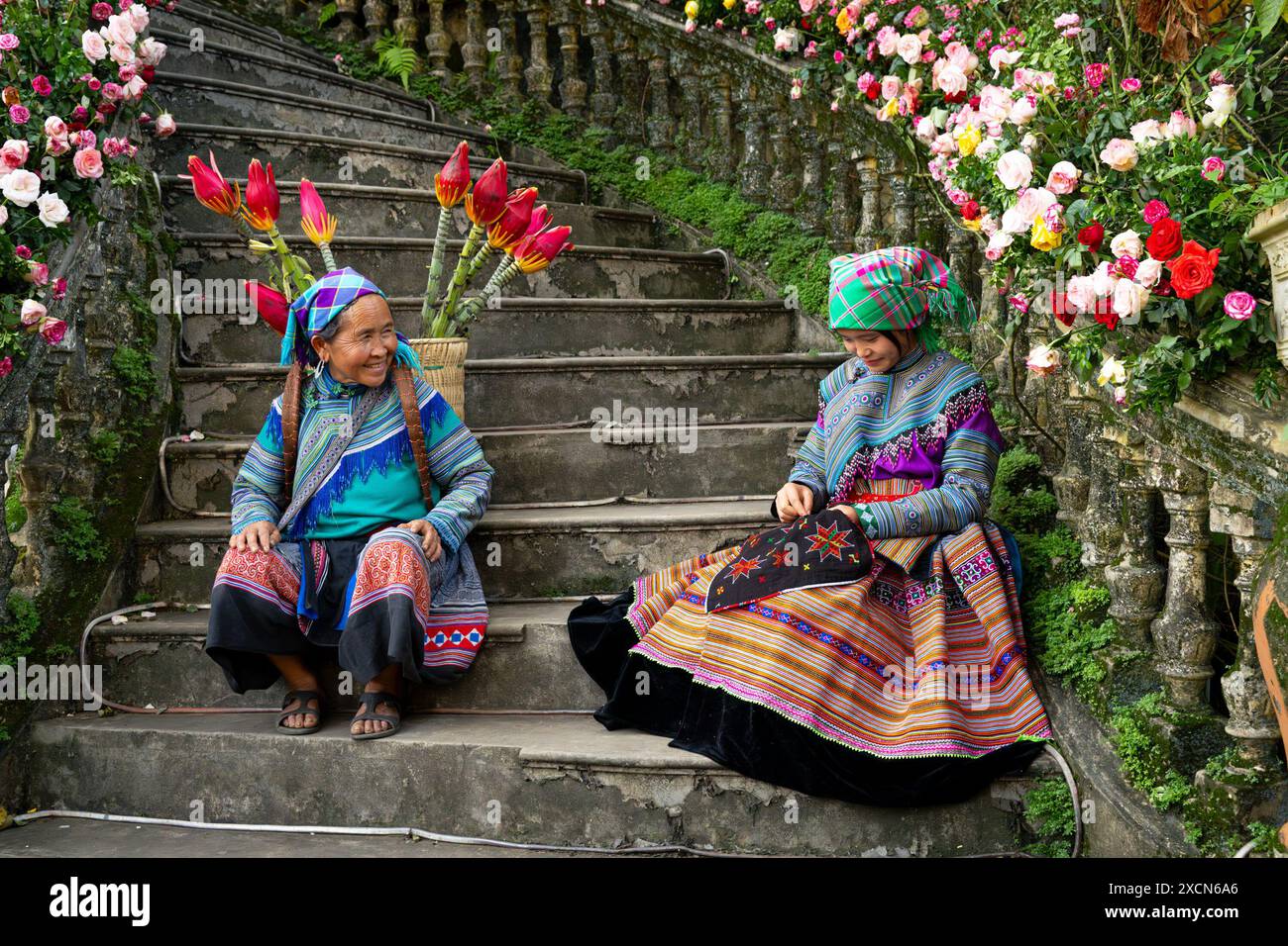 Flower Hmong woman sitting on the stairs of the Hmong Kings Palace (Vau ...