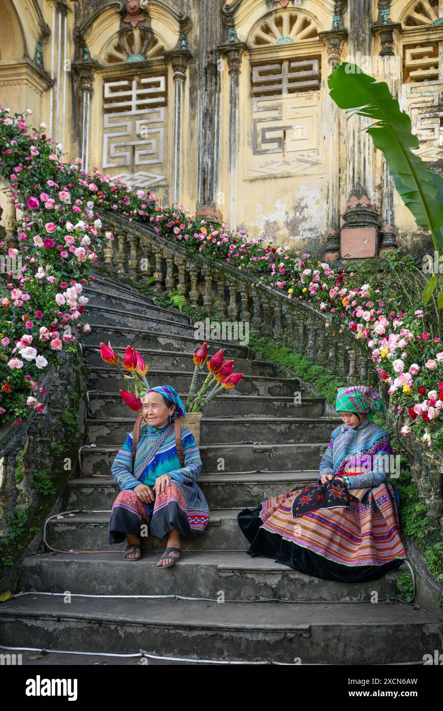 Flower Hmong woman sitting on the stairs of the Hmong Kings Palace (Vau ...