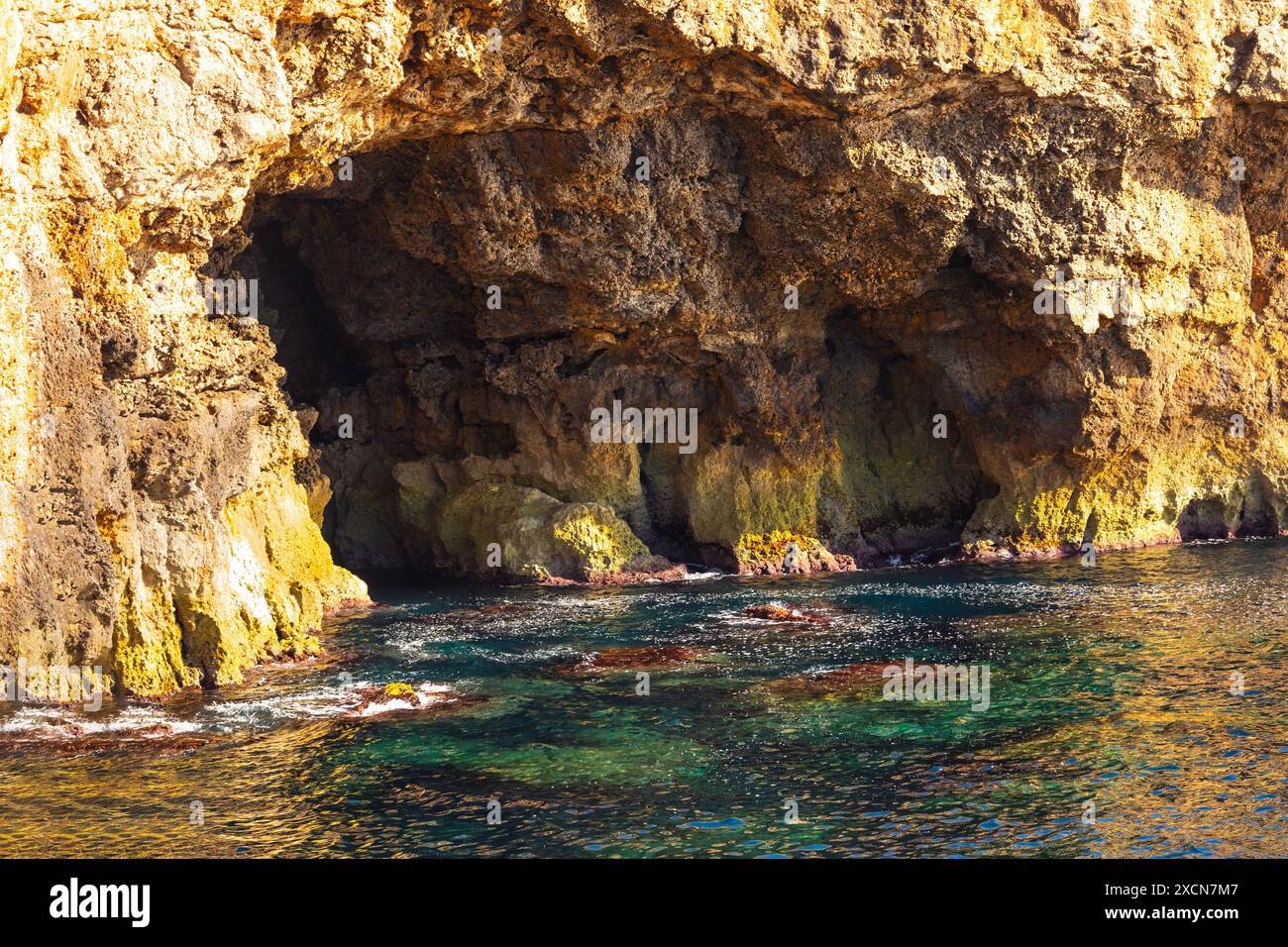 Cave in the coastal rock. Coastal erosion caused by waves Stock Photo ...