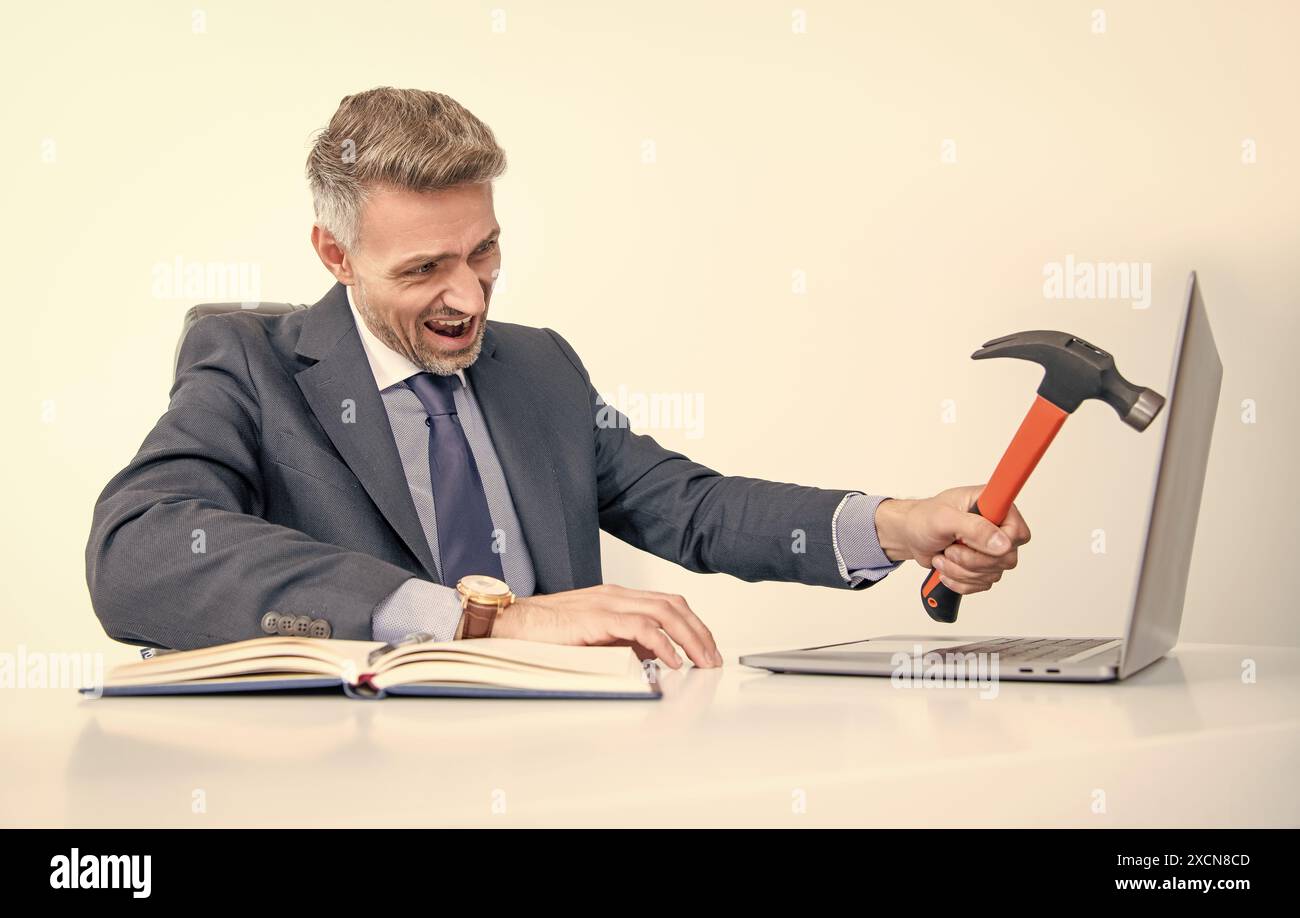 aggressive boss hitting laptop with hammer in office Stock Photo - Alamy