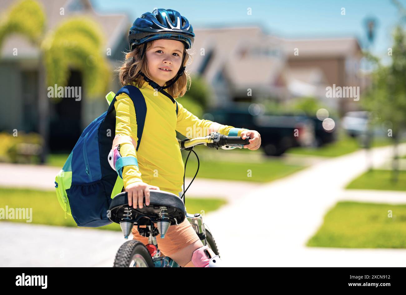 Little kid boy riding a bike in summer park. Child drive a bike on a ...