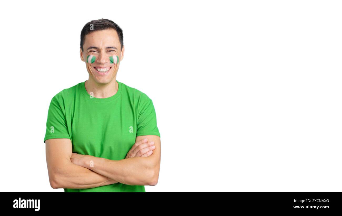 Man standing with nigerian flag painted on face smiling Stock Photo - Alamy
