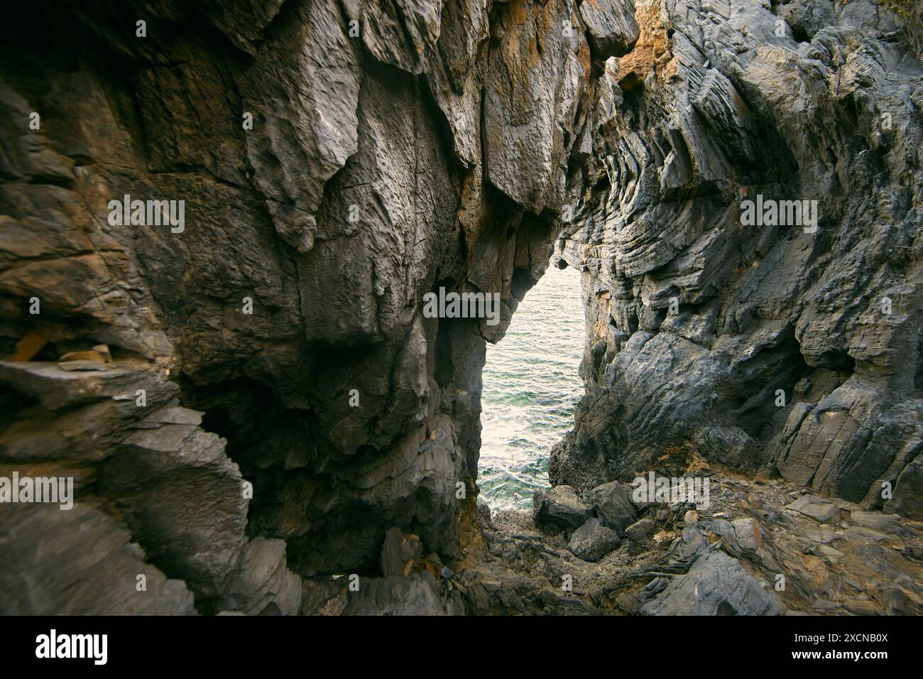 The rock cliff with the blue sea at Tham Phang Beach in Koh Si Chang ...