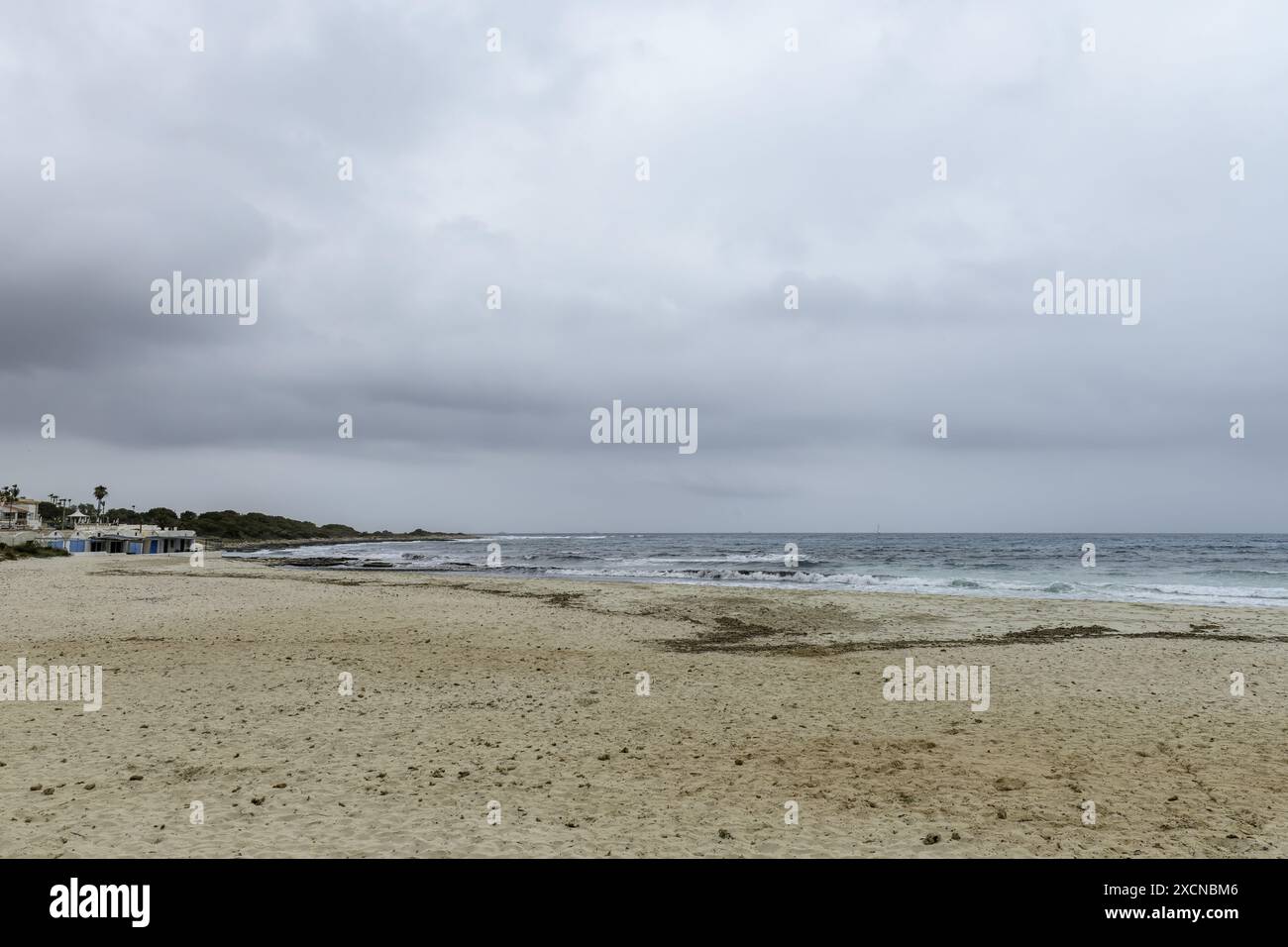 A peaceful view of Punta Prima Beach in Menorca, showcasing a sandy ...