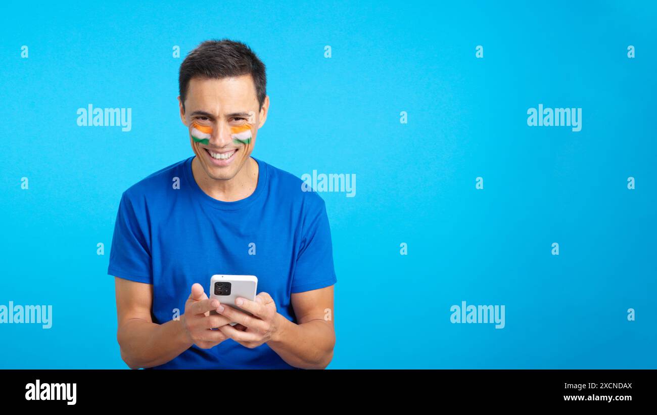 Indian man looking at his mobile smiling and showing it Stock Photo - Alamy