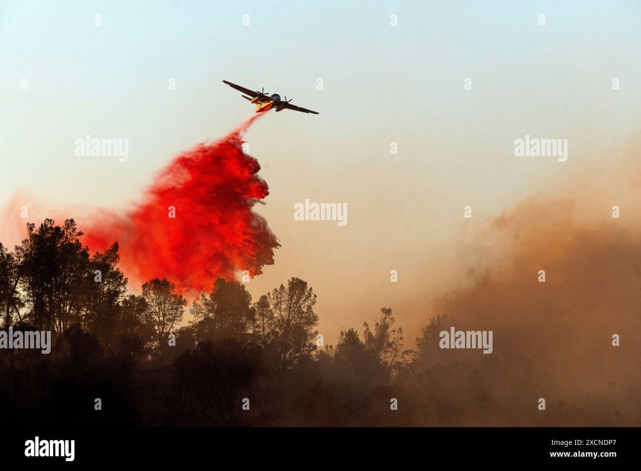 An air tanker drops retardant while battling the Aero Fire in the ...