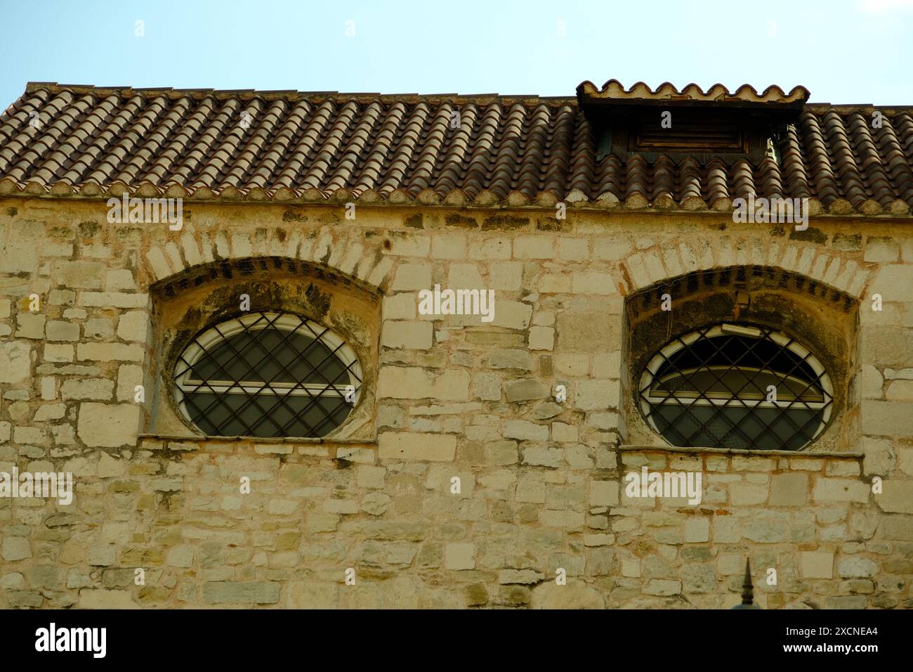 The building has two windows, one on the left and one on the right. The ...