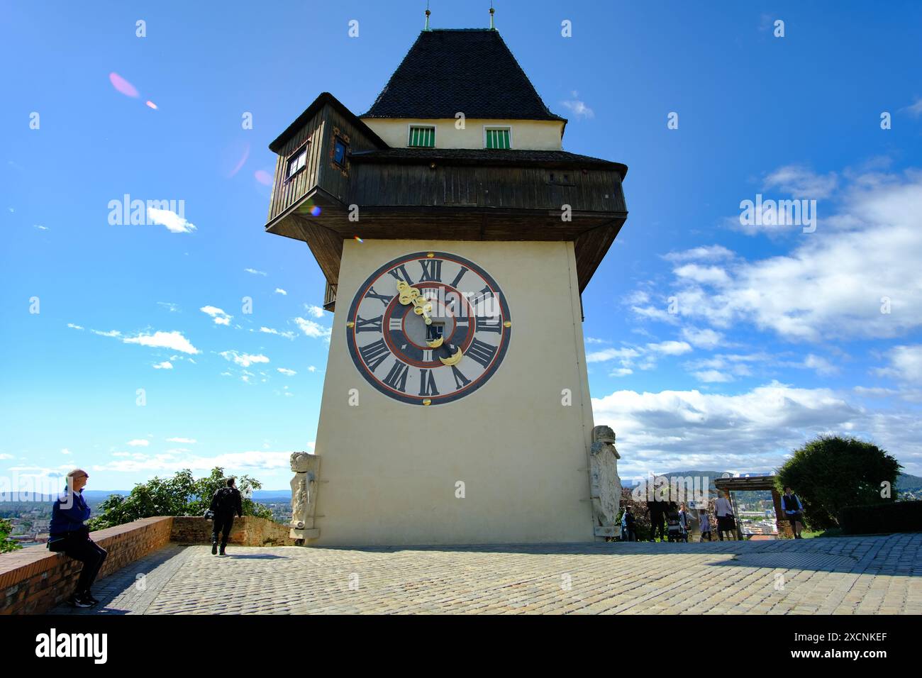 A clock tower with a large clock face and a small clock on the side ...