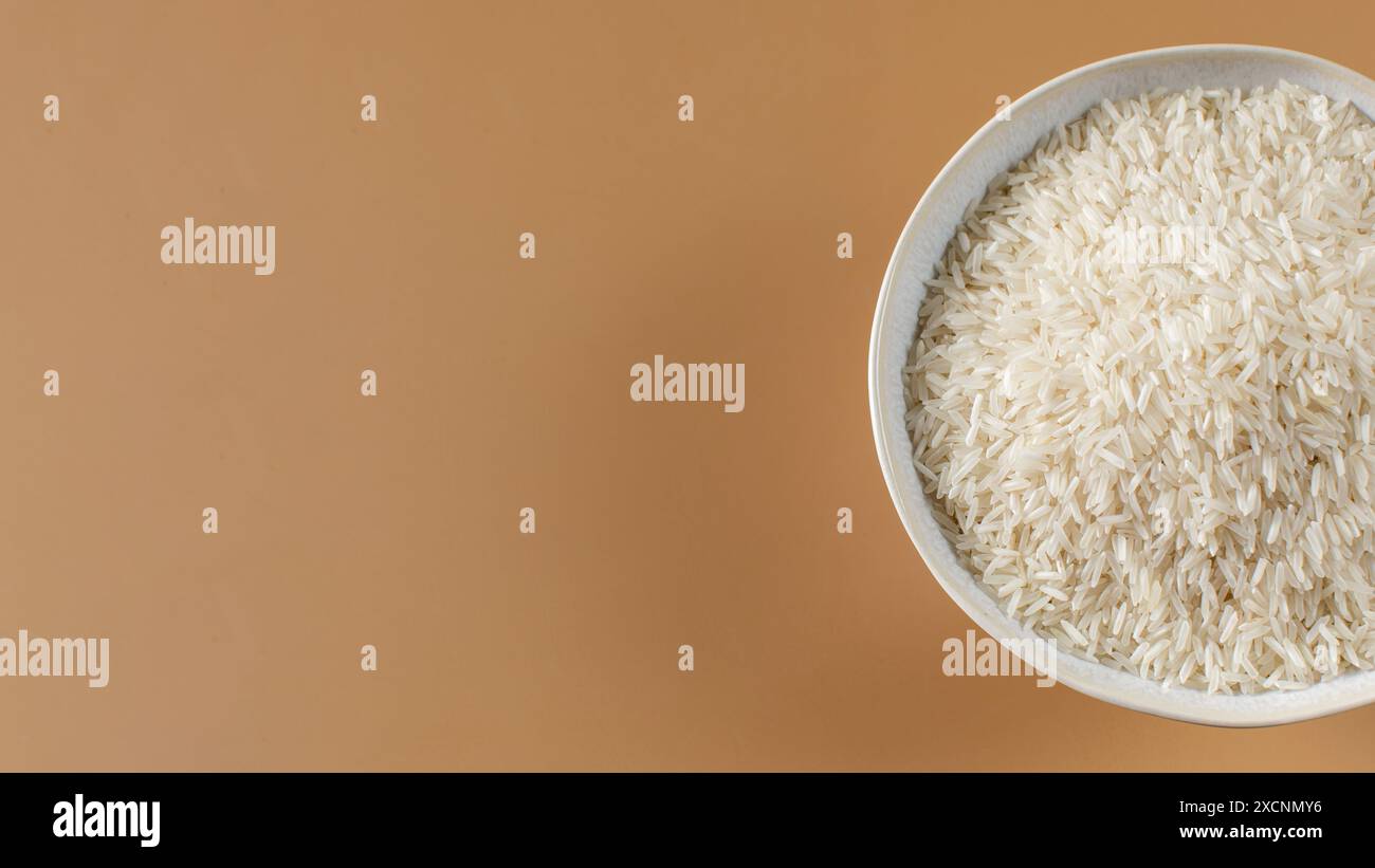 Bowl of aromatic basmati rice on light brown background Stock Photo - Alamy