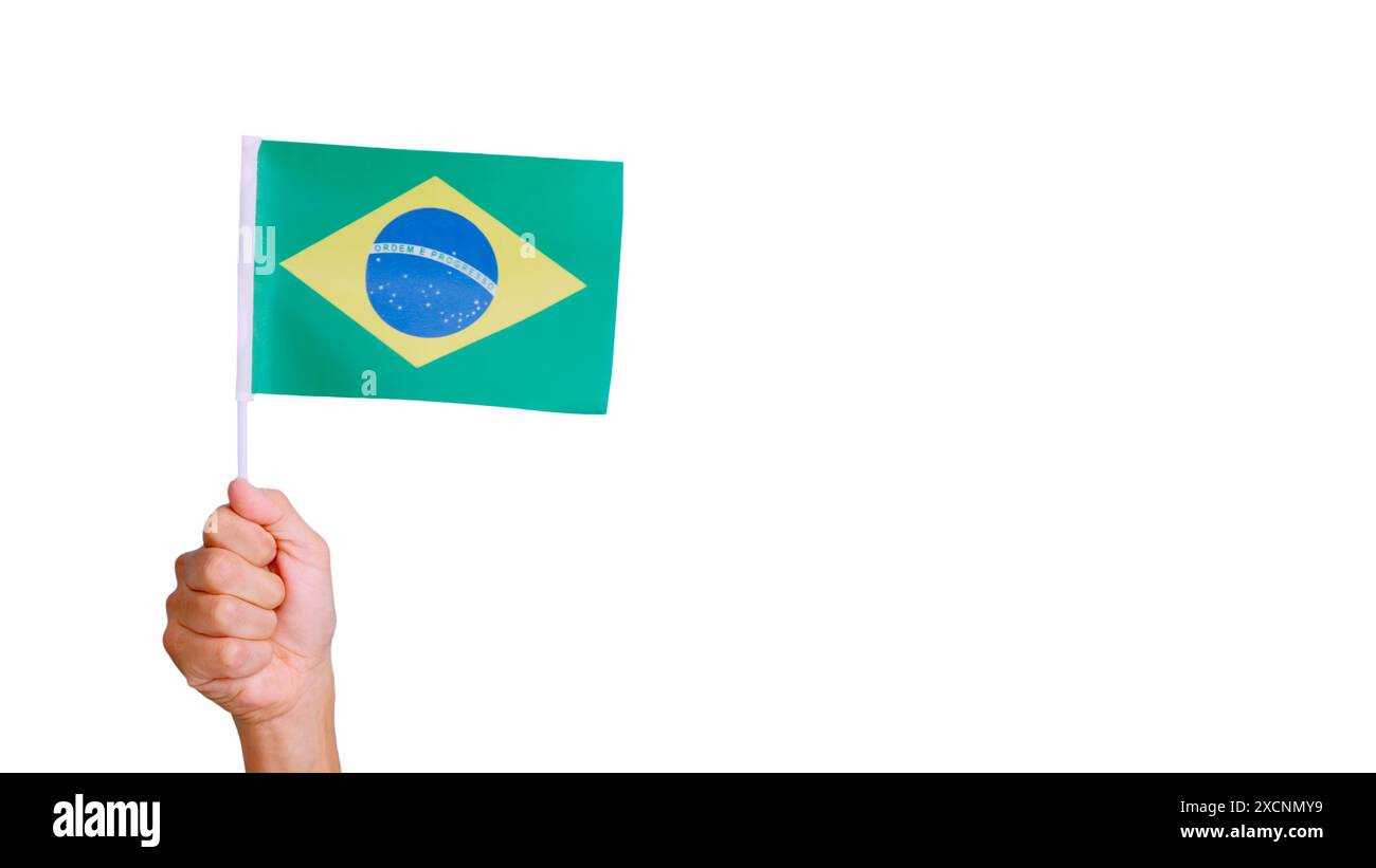 Wind waving a brazilian pennant holding by a person Stock Photo - Alamy