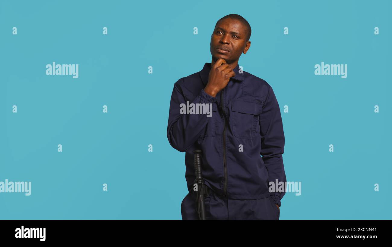 Security guard doing thinking hand gesture, being tasked with ...