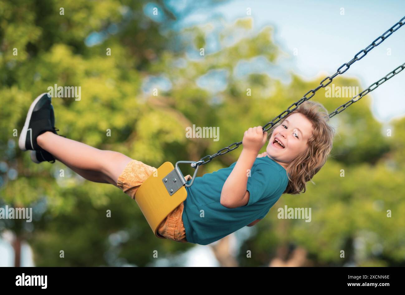 Little kid swinging portrait. Adorable child having fun on a swing on ...
