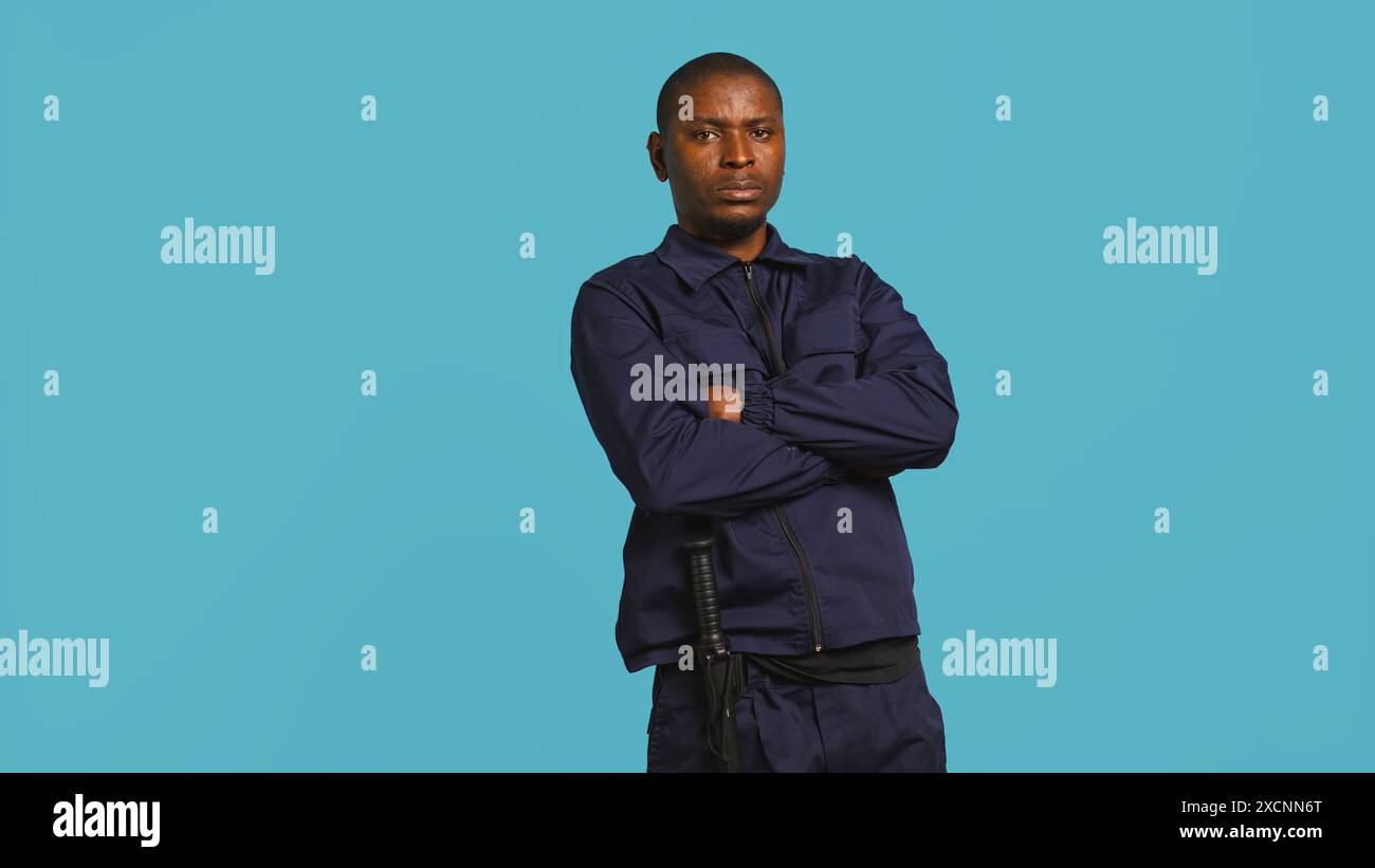 Security guard in threatening pose, tasked with preventing criminal ...