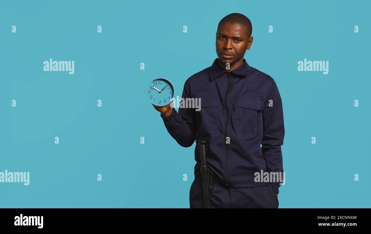 Security guard holding clock, rushing people out of property. Portrait ...