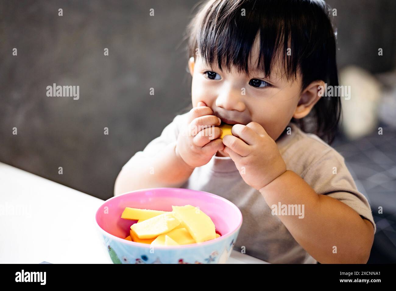 Cute boy eating mango at home. Asian child with healthy nutrition Stock ...