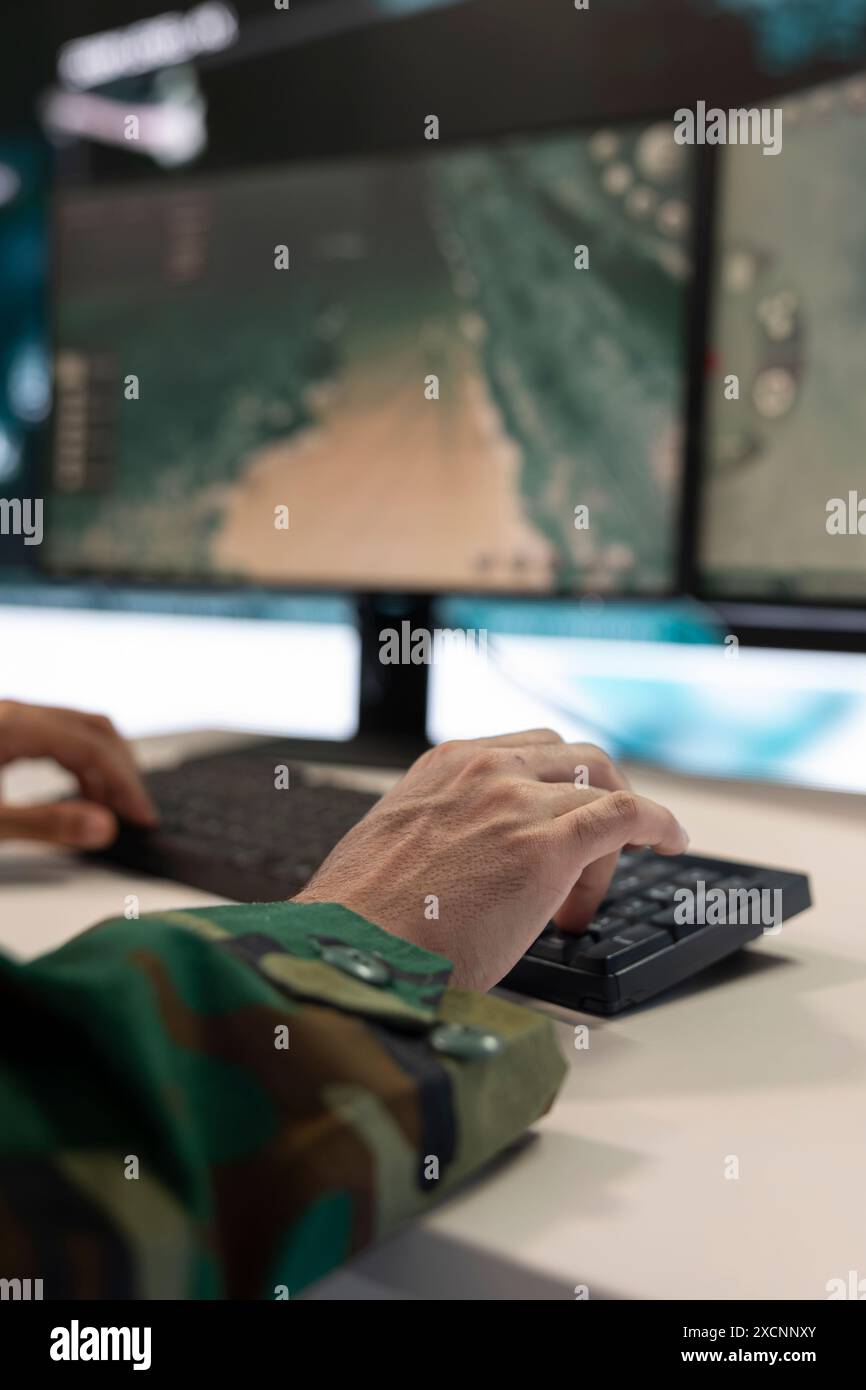 Combat IT engineer supervising and assisting team members in the field ...