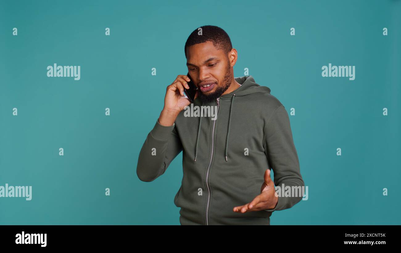 Irked african american man fighting with friends during telephone call ...
