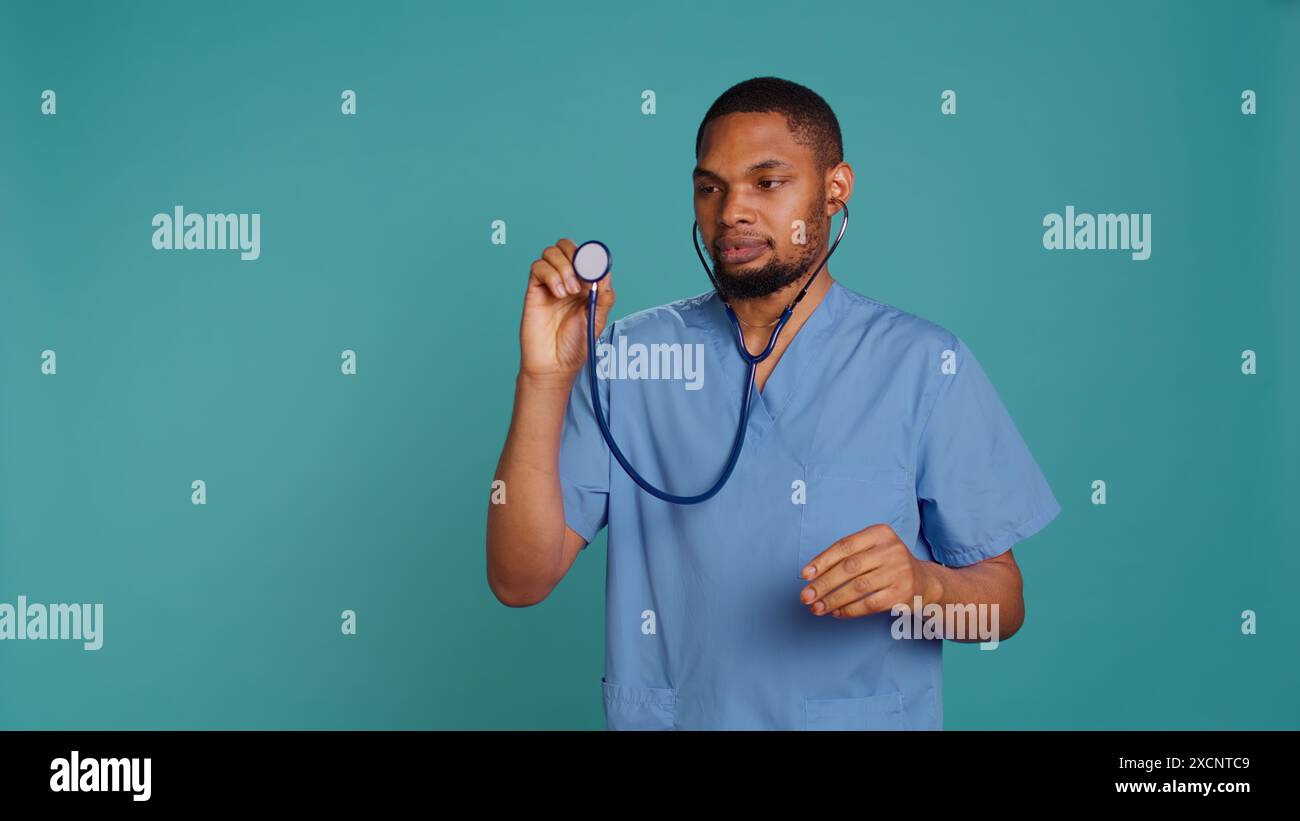 Male nurse using stethoscope on patient during medical exam, hearing ...