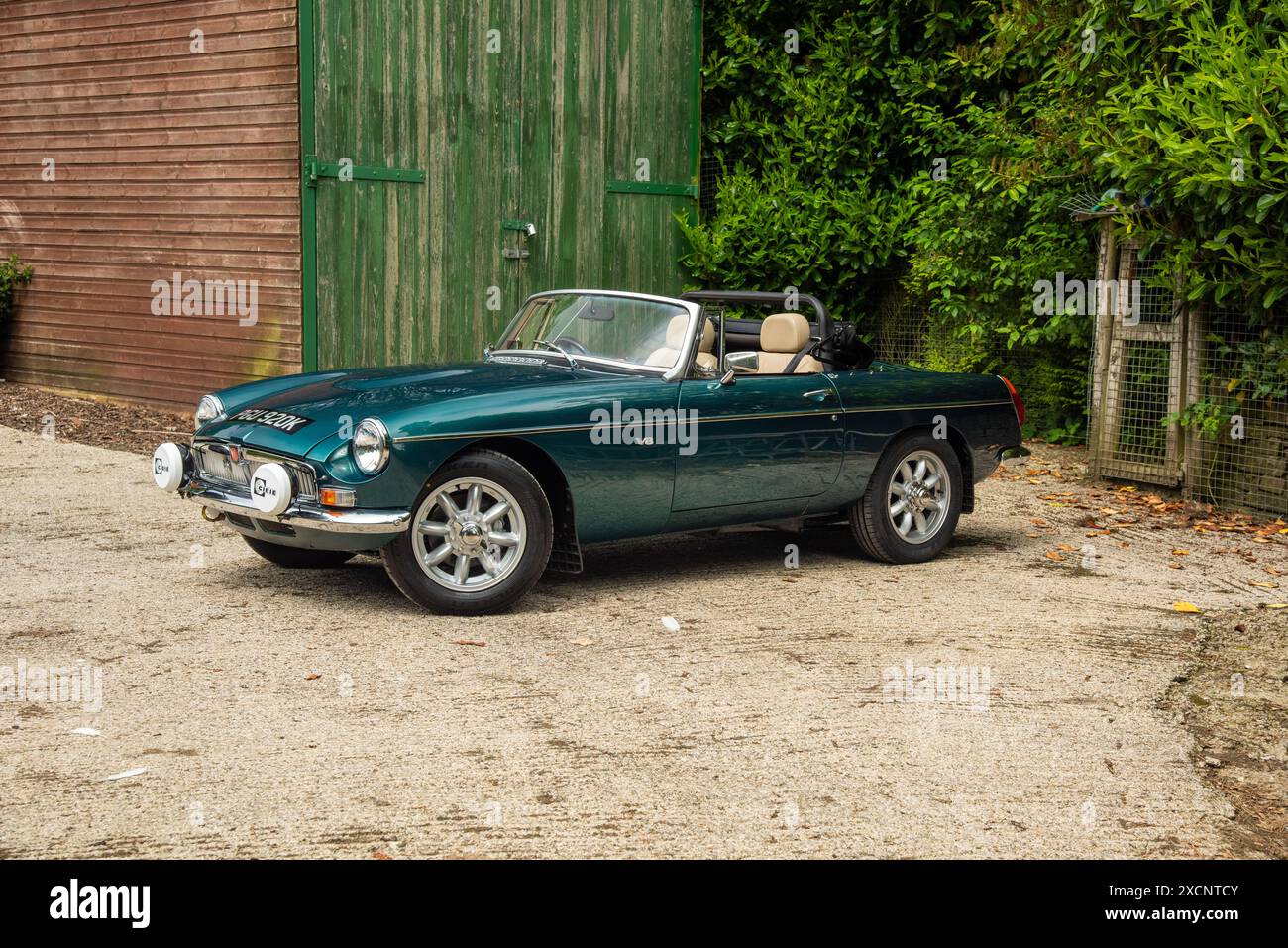 MGB roadster rally car parked on a gravel drive in front of an old ...
