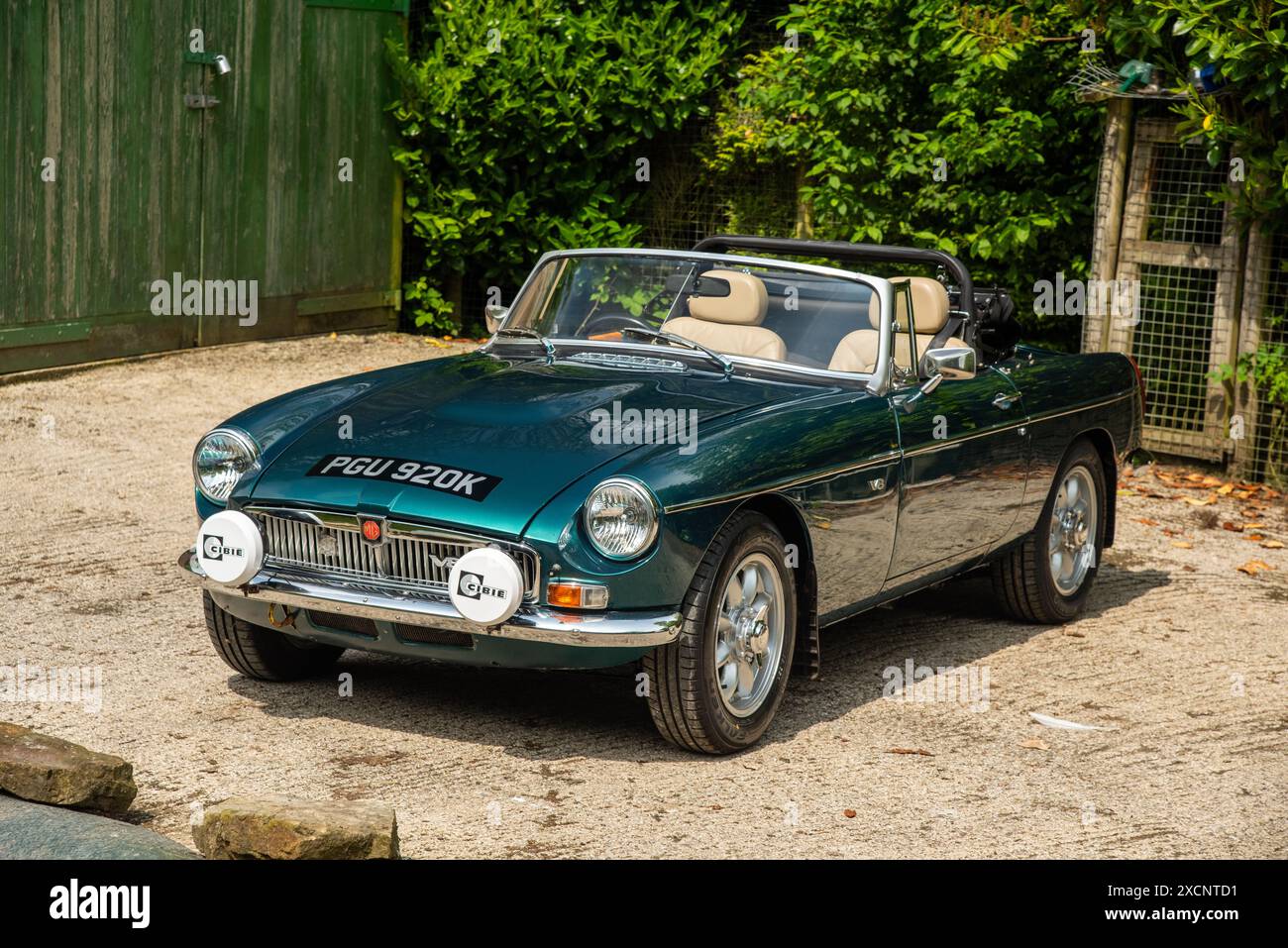 MGB roadster rally car parked on a gravel drive in front of an old ...