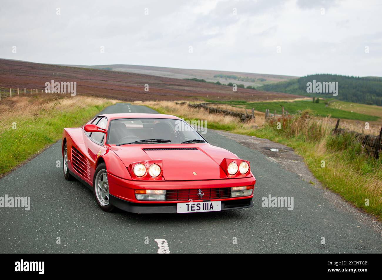 An Eighties Ferrari Testarossa with its pop-up headlights up standing ...