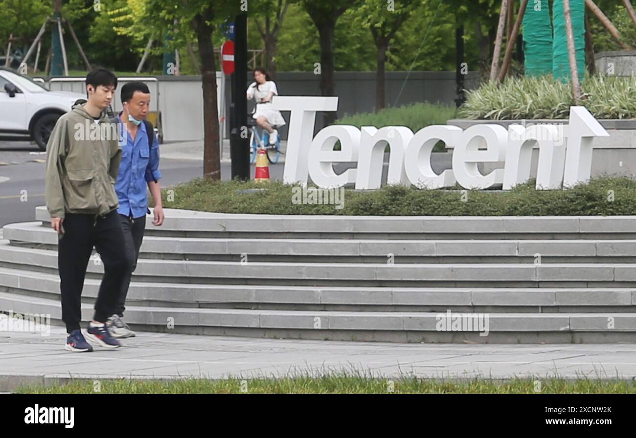 SHANGHAI, CHINA - JUNE 10, 2024 - Citizens walk past the Tencent ...
