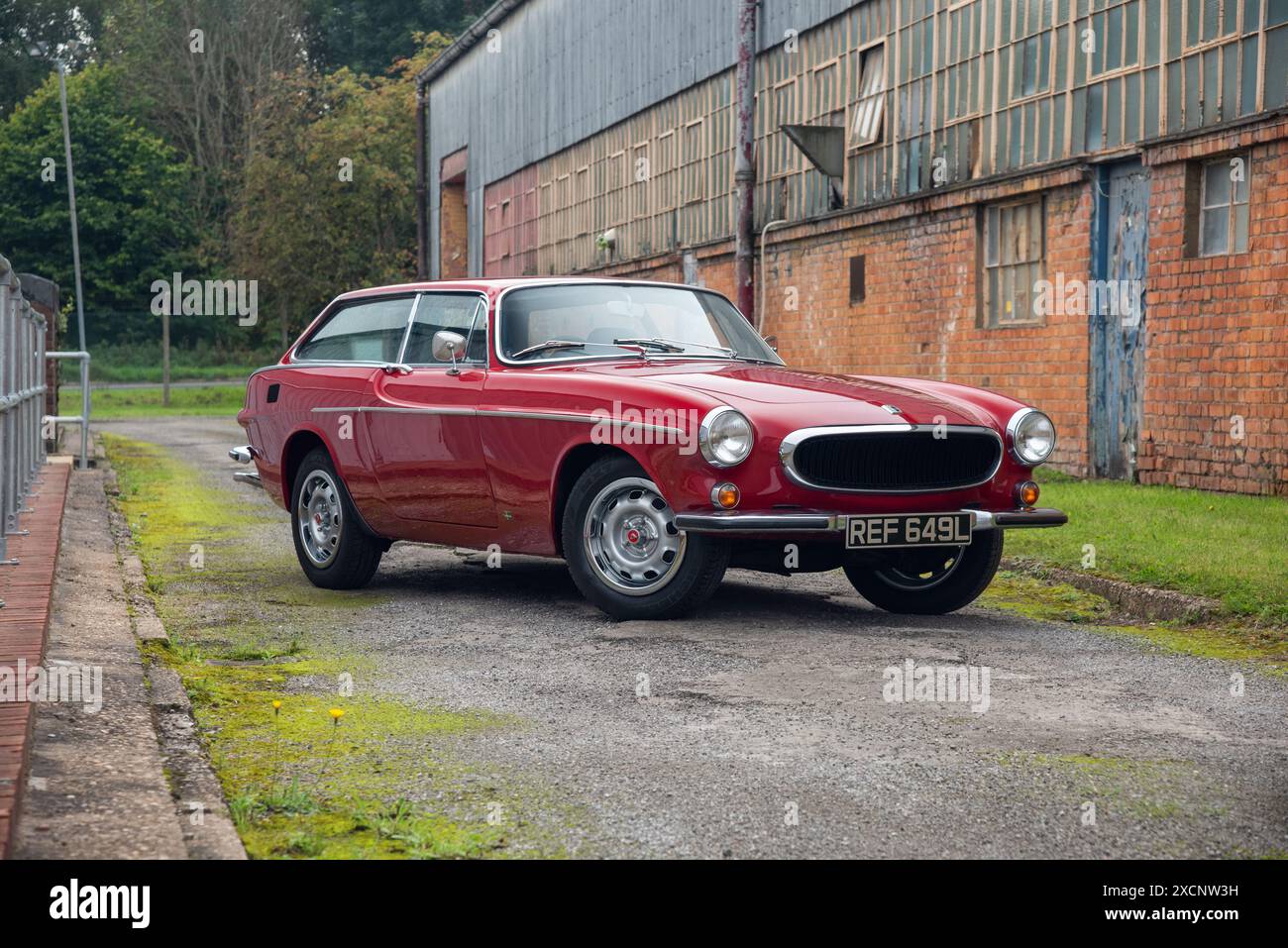 Volvo 1800 ES shooting brake parked on a lane by an old factory ...