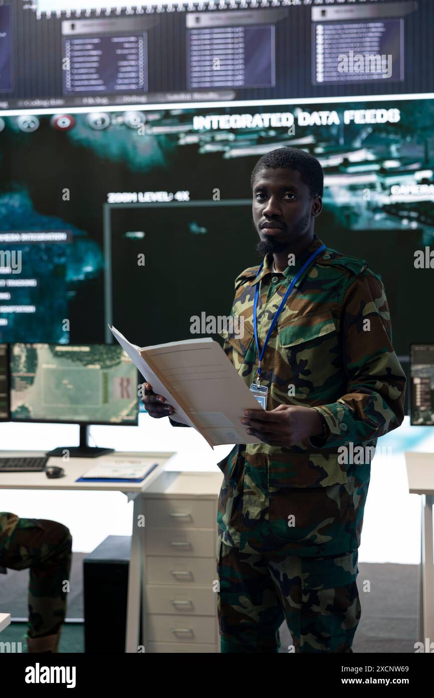 Navy operations specialist reading new mission case files in command ...