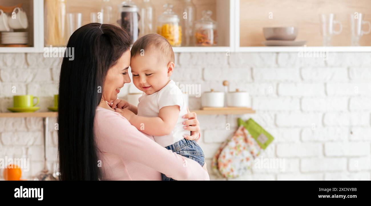 Woman Holding Baby in Arms, Blank Space Stock Photo - Alamy