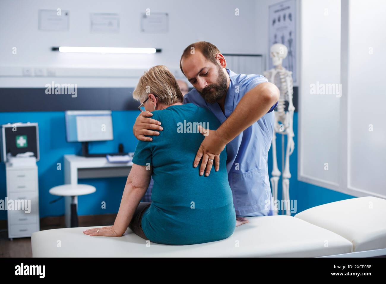 Orthopedic doctor relieving pressure from back bones of retired patient ...