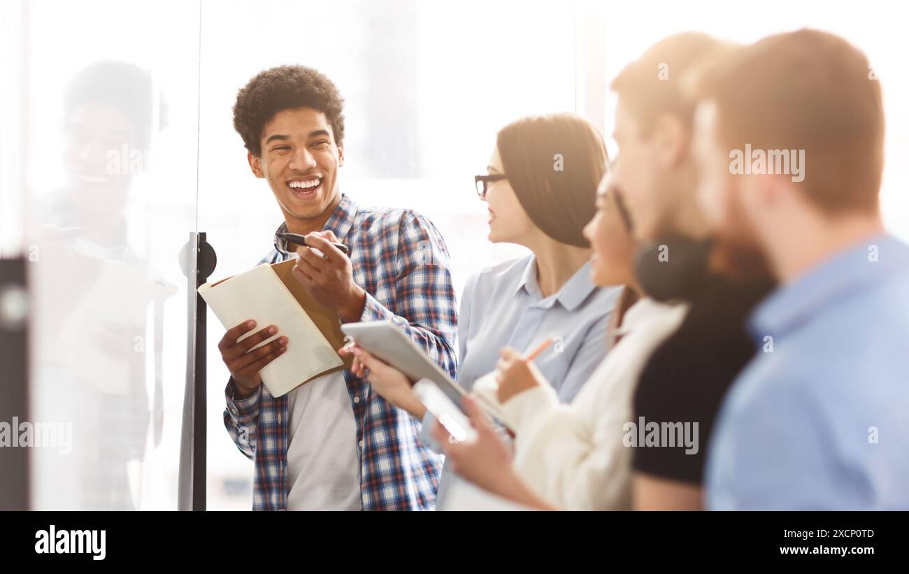 Learning concept. Students discussing tasks on whiteboard Stock Photo ...